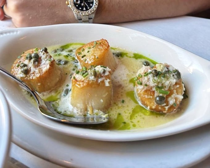 Golden seared scallops swimming in butter sauce with capers&mdash;ocean candy that makes you wonder why we bother with actual dessert.