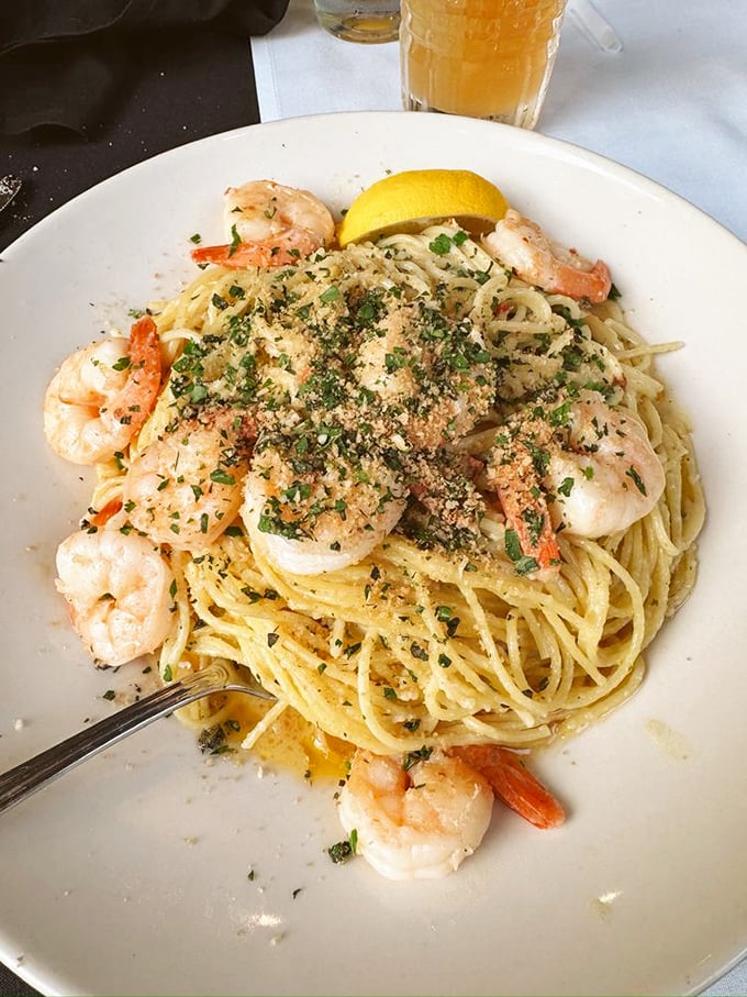 Shrimp scampi that's dressed for success &ndash; plump crustaceans perched atop pasta strands glistening with garlic butter and sprinkled with herbs.
