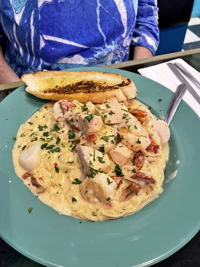 Seafood and pasta living their best lives together in a creamy sauce that would make an Italian grandmother nod in approval.