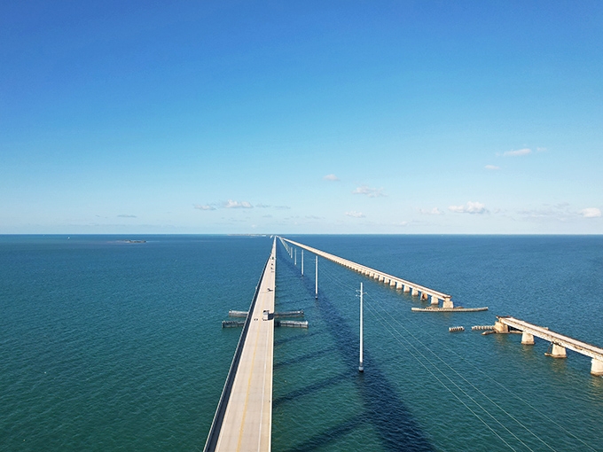 Engineering marvel meets natural wonder as the Seven Mile Bridge stretches toward the horizon like a concrete tightrope over paradise.