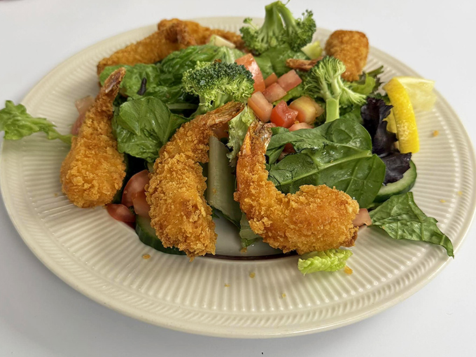 Even salads get the royal treatment here &ndash; crispy golden shrimp perched atop fresh greens proves that "diner food" and "light option" aren't mutually exclusive concepts.
