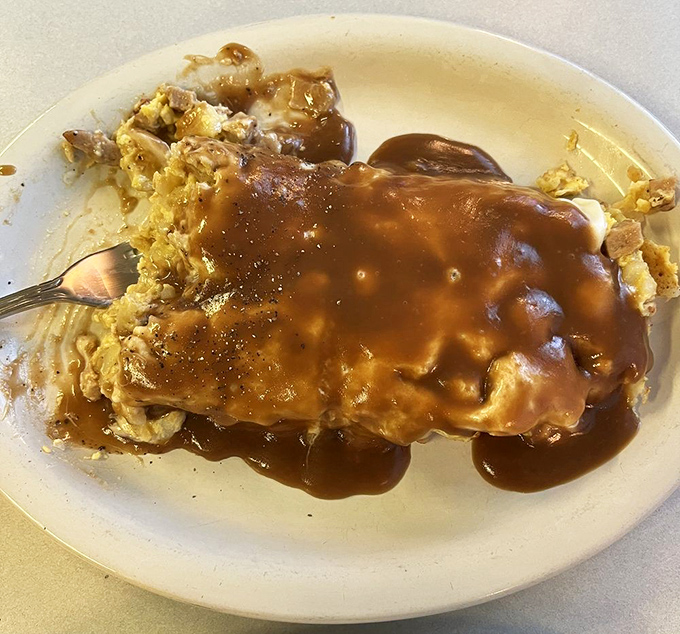 Gravy isn't just a condiment here&mdash;it's practically a religion. This open-faced sandwich drowning in savory goodness makes you want to convert immediately.