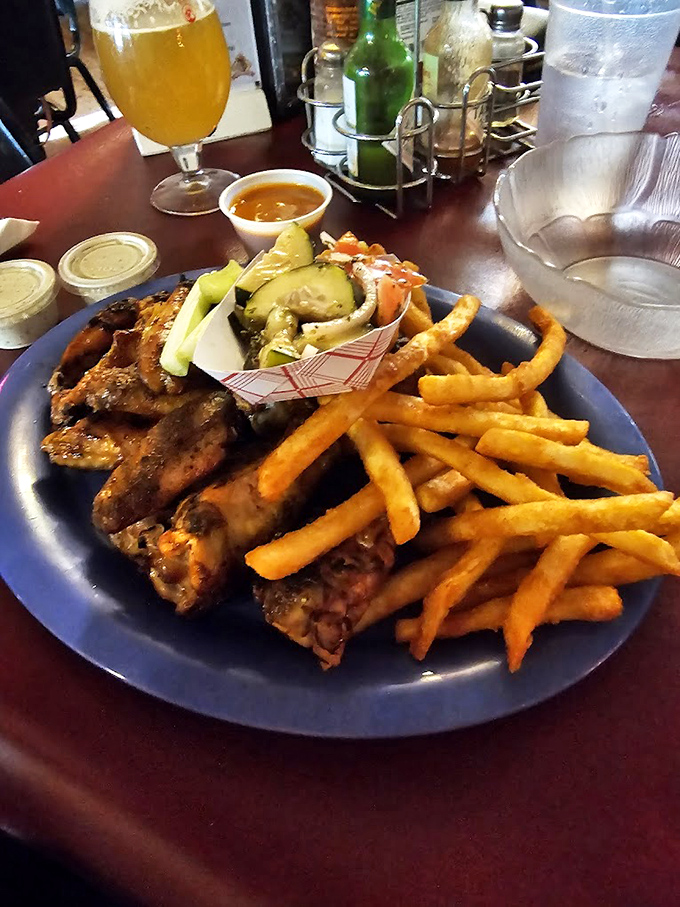 Wings, fries, and all the fixings—proof that barbecue joints excel beyond just the classics. That golden-brown chicken skin is practically winking at you.