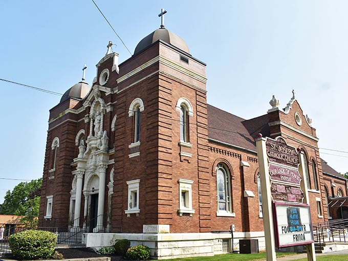 St. Joseph Church rises in red brick splendor, its twin spires reaching skyward like an architectural prayer in the heart of Ashtabula.