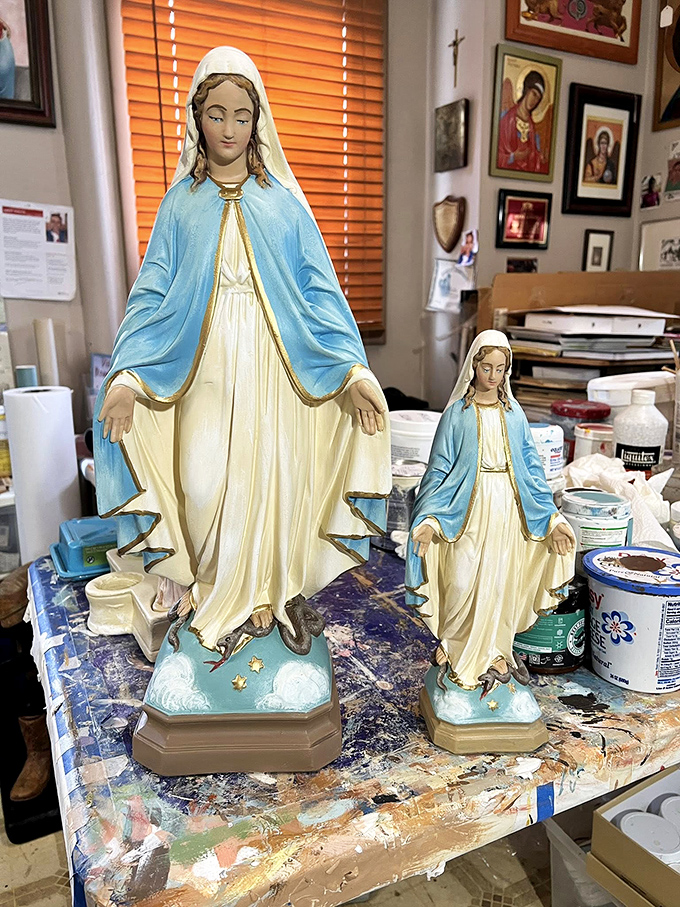 Religious statues await restoration in this art studio, where Mount Carmel's cultural traditions are preserved with skilled hands and devoted hearts.