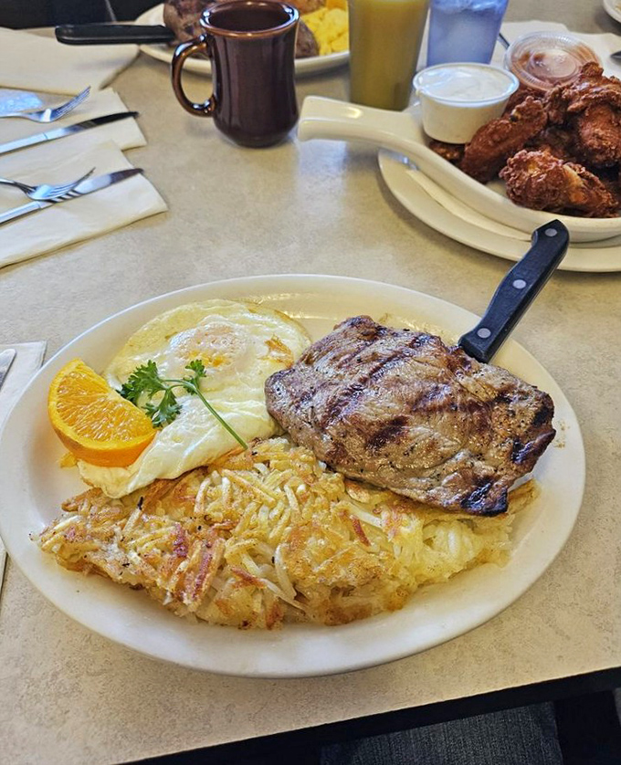 The steak and eggs platter&mdash;where morning meets evening in perfect harmony. Those hash browns deserve their own fan club.