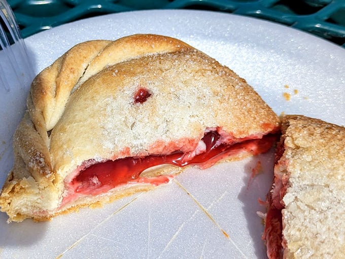 Sweet meets tart in this strawberry pasty &ndash; the crimson filling peeking through a sugar-dusted crust. Dessert or breakfast? At Muldoons, no one's judging either way.