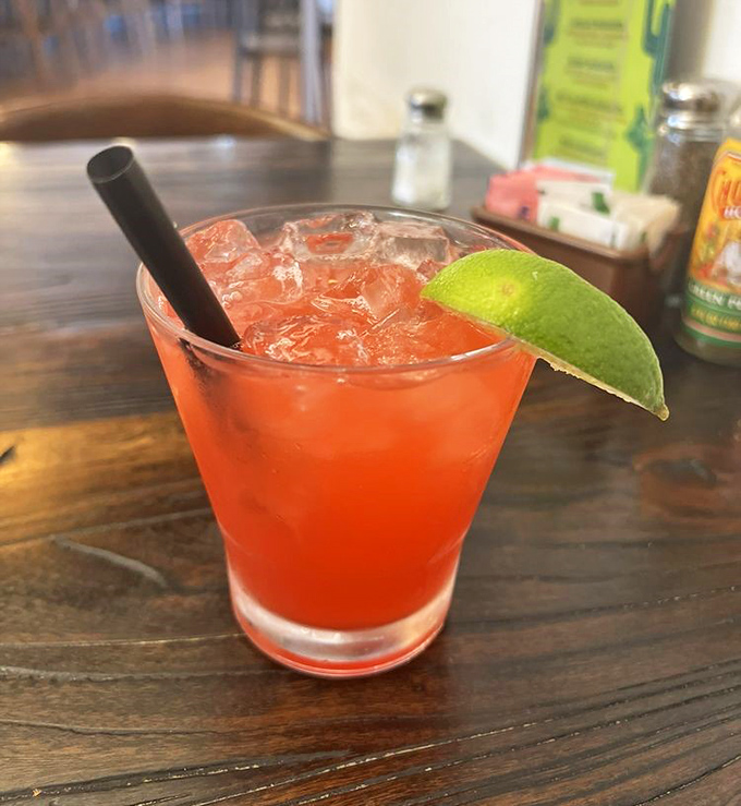 A strawberry margarita that's dressed for success—vibrant, refreshing, and sporting a lime wedge hat that says "the weekend starts now."