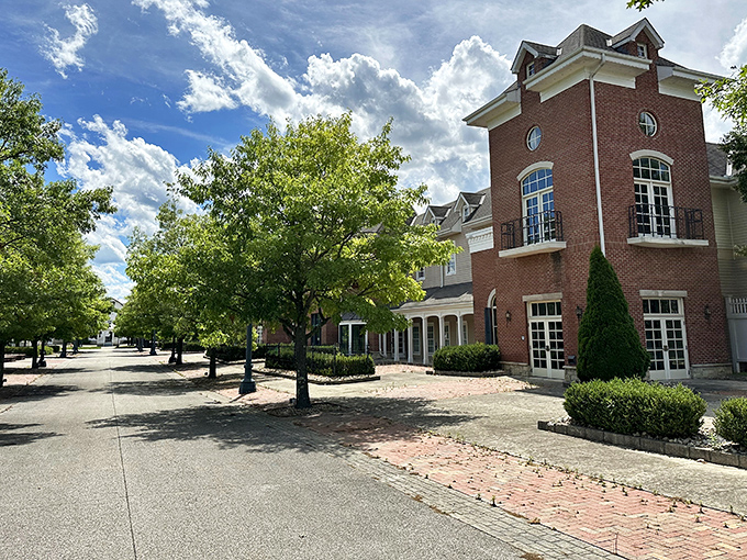 Brick buildings and manicured grounds surround the basket, creating a charming small-town square that happens to feature an absolutely enormous fruit container.