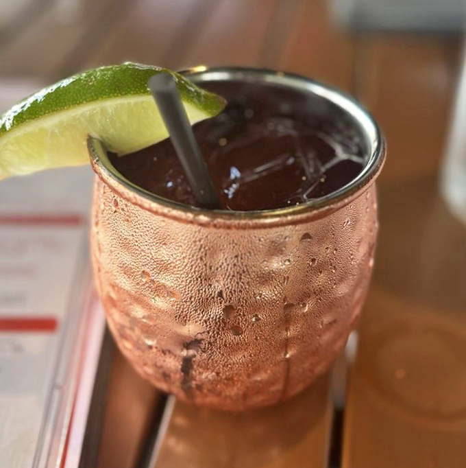 A Moscow Mule that's dressed better than most people at the restaurant. That copper mug isn't just for show—it's keeping your drink cold while making you look sophisticated.