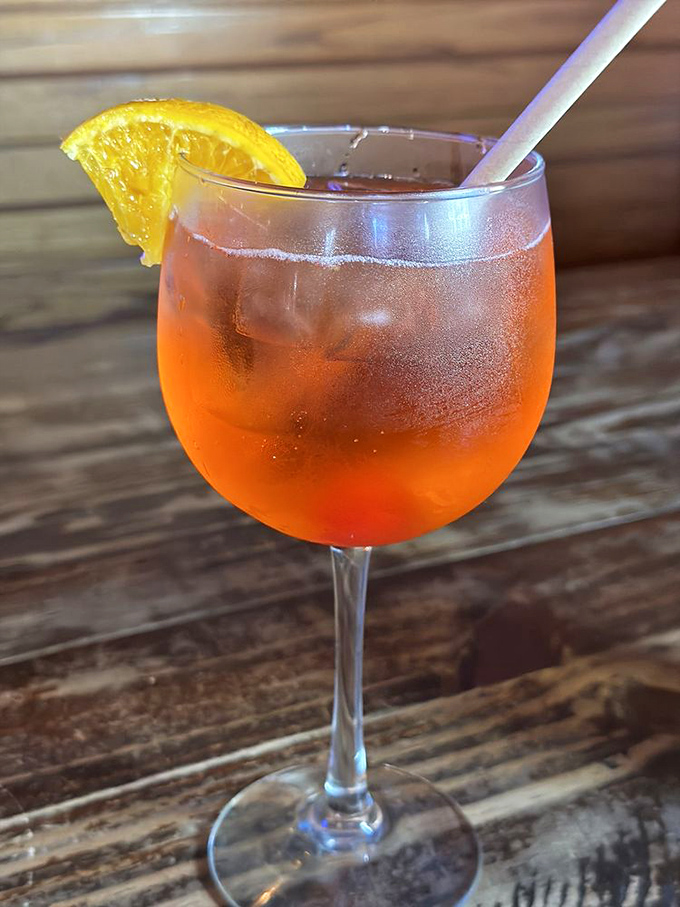 That sunset-colored spritz isn't just a drink; it's Florida sunshine in liquid form, complete with the perfect orange garnish.