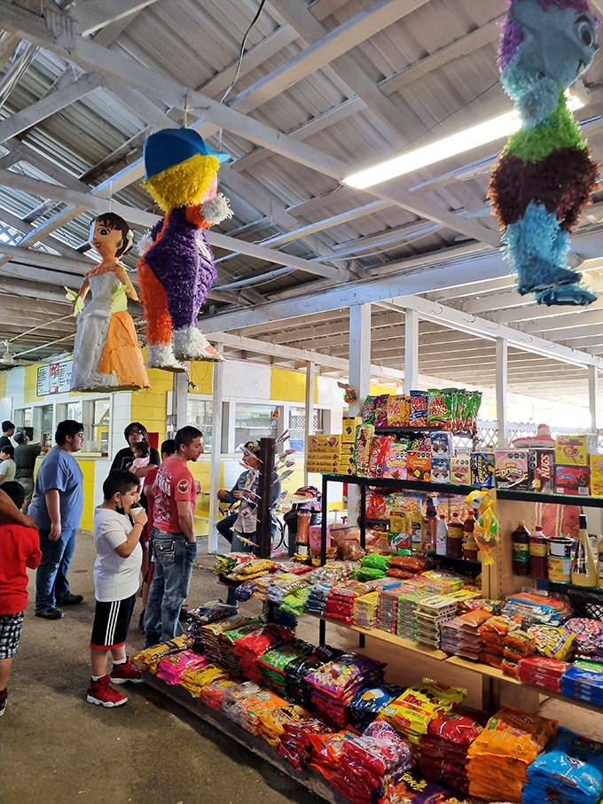Pi&ntilde;atas watch from above as a candy kingdom unfolds below. This sugar-coated corner would make Willy Wonka himself stop and stare.