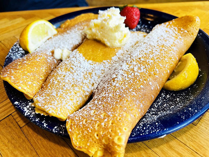 This golden crepe, delicately folded and dusted with powdered sugar, proves that sometimes the simplest pleasures are the most satisfying.