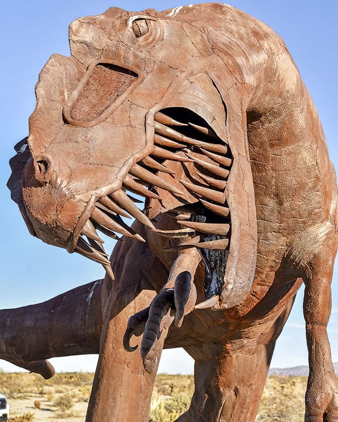 The T-Rex's skeletal design offers a fascinating glimpse inside the predator's anatomy, its ribcage open to the desert air like a prehistoric anatomy lesson.