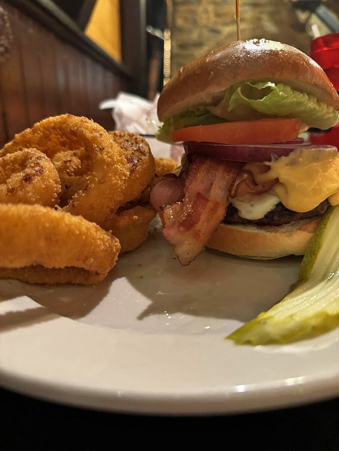 The Mount Joy Burger stacks up like a delicious architectural marvel with crispy onion rings.