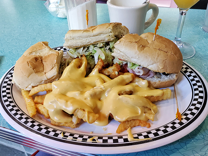 Cheese sauce cascading over fries and sandwiches standing at attention—a plate that says "I dare you to leave hungry."
