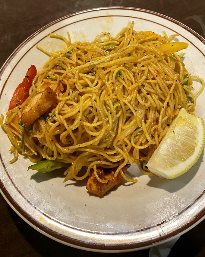 Tibetan chicken fried rice that defies gravity with its perfectly separated grains. That lemon wedge isn't just garnish—it's the finishing touch of genius.
