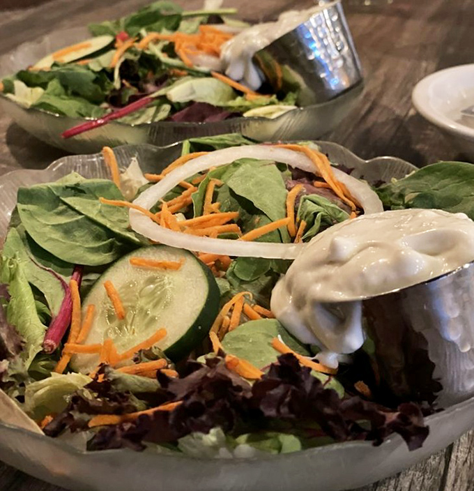 Even the salad gets the respect it deserves. Fresh greens, crisp vegetables, and that dollop of dressing—the opening act that sets the stage for seafood stardom.