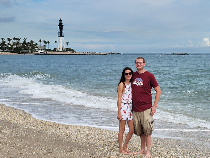 The lighthouse creates the perfect backdrop for memories, standing sentinel as visitors capture their moment in this slice of Florida paradise.