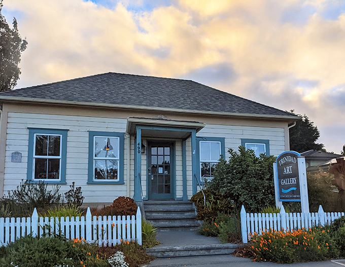 The Trinidad Art Gallery welcomes visitors with a white picket fence and cottage charm that screams "come in and find something you didn't know you needed."