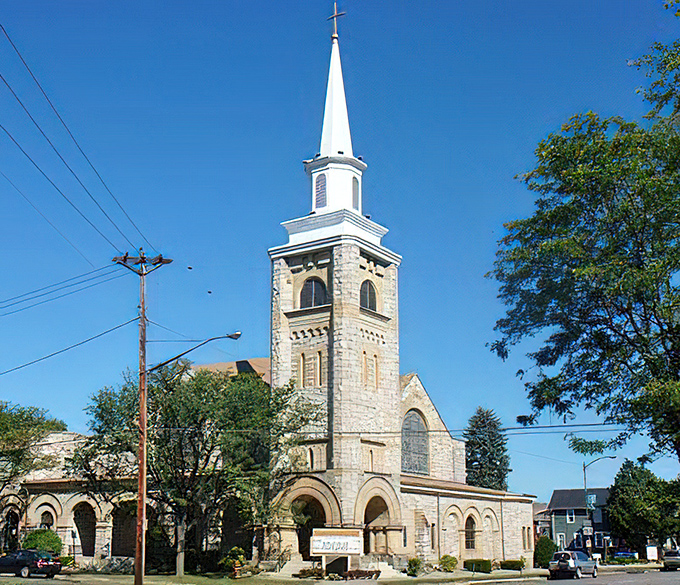Trinity United Methodist Church reaches skyward with limestone elegance. Its soaring spire serves as both spiritual beacon and navigational landmark for downtown explorers.