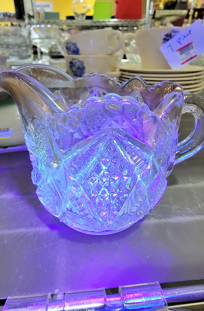 Iridescent glass pitcher catching light like a crystal ball, possibly predicting your future as its new owner.