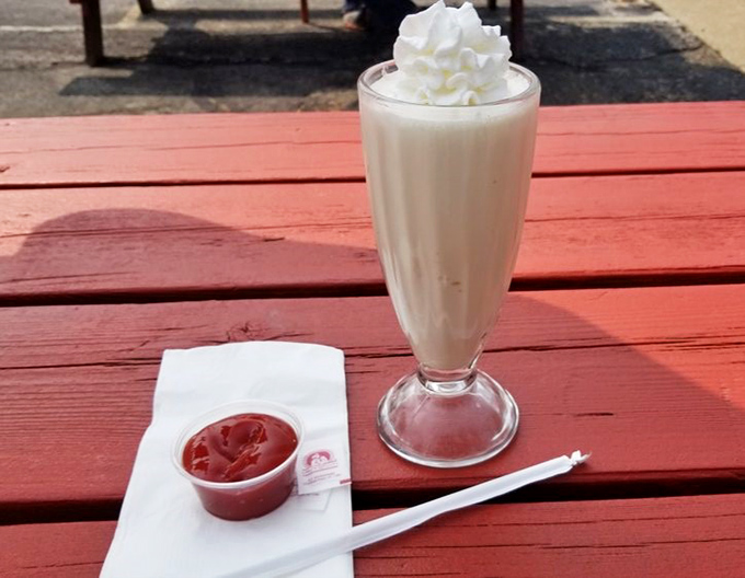 Topped with a cloud of whipped cream, this vanilla milkshake isn't just a beverage—it's dessert in a glass that makes waiting for your burger a pleasure, not a chore.