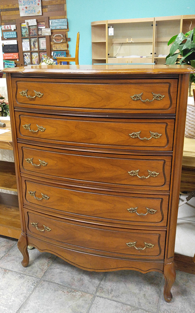 This French Provincial dresser has seen more outfit changes than a Broadway production. Solid wood craftsmanship that puts your particle board IKEA pieces to shame.