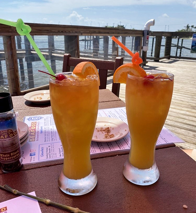 Tropical drinks with colorful straws and a waterfront view – because sometimes Monday needs to feel like Saturday, even when it's actually Tuesday.