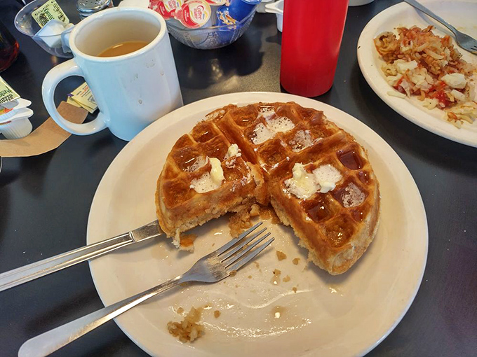 The Belgian waffle: golden, crispy exterior giving way to a fluffy interior. Butter melting into each perfect square like it was designed to do exactly that.