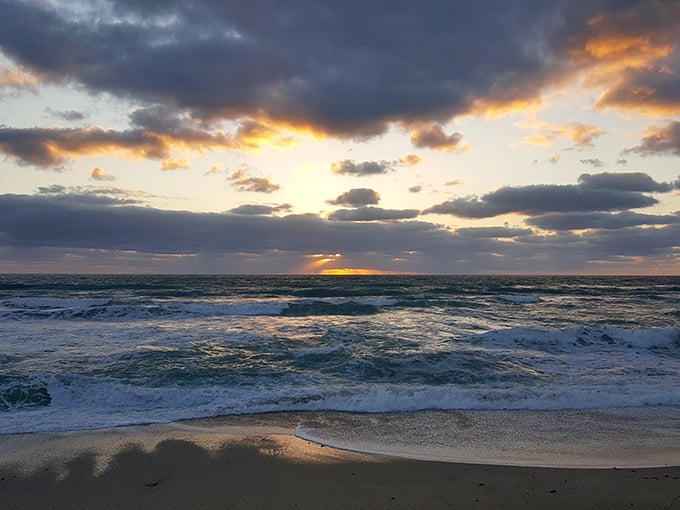 Waveland Beach at sunset—where the Atlantic performs its nightly color show without charging admission. Nature's Netflix, but better.