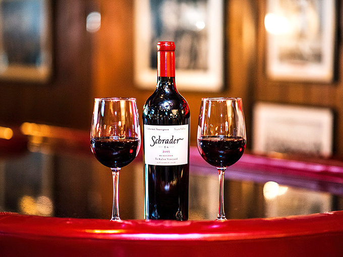 A bottle of Schrader Cabernet between two glasses&mdash;because great steak deserves equally great wine. The perfect relationship doesn't exi&mdash;oh wait, here it is.