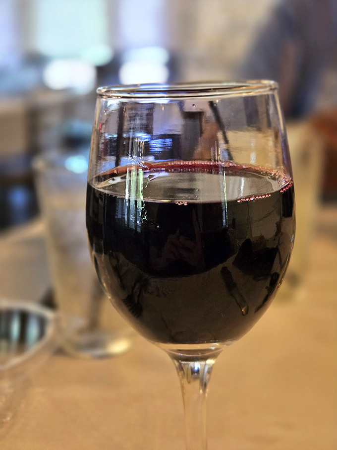 A perfectly poured glass of red wine - the ideal companion for an evening of indulgence.