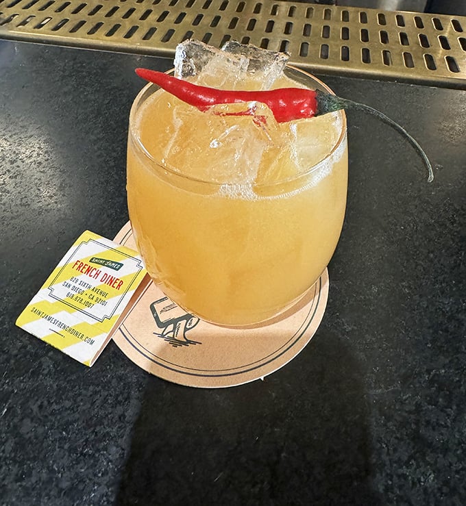 This cocktail isn't just refreshing—that chili pepper garnish is the bartender's way of saying "trust me, this relationship is about to get interesting."