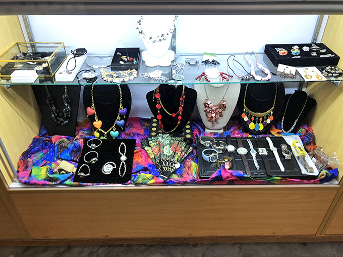 The jewelry display case sparkles with possibilities – from statement pieces to subtle elegance, all at thrift store prices.