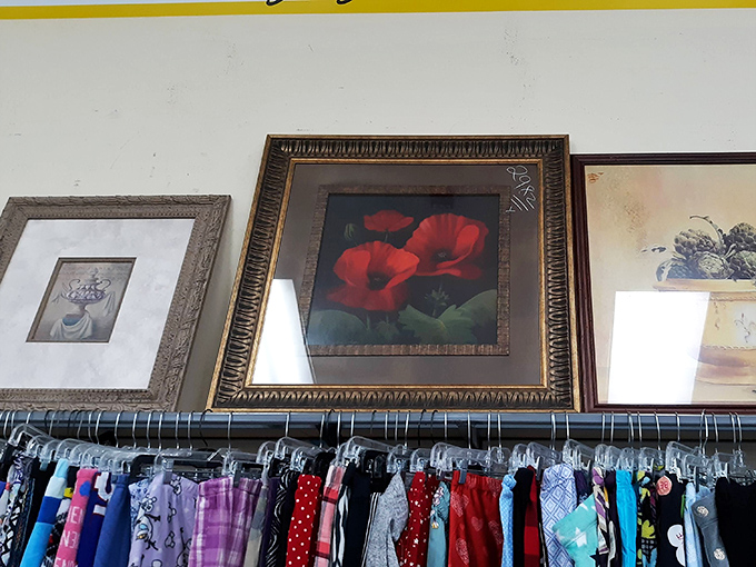 Framed artwork lines the walls above clothing racks, offering the chance to own those iconic red poppies without the Monet-level investment.