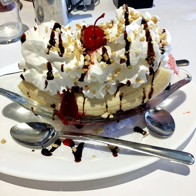 This banana split is basically childhood joy served in a glass boat with extra whipped cream.