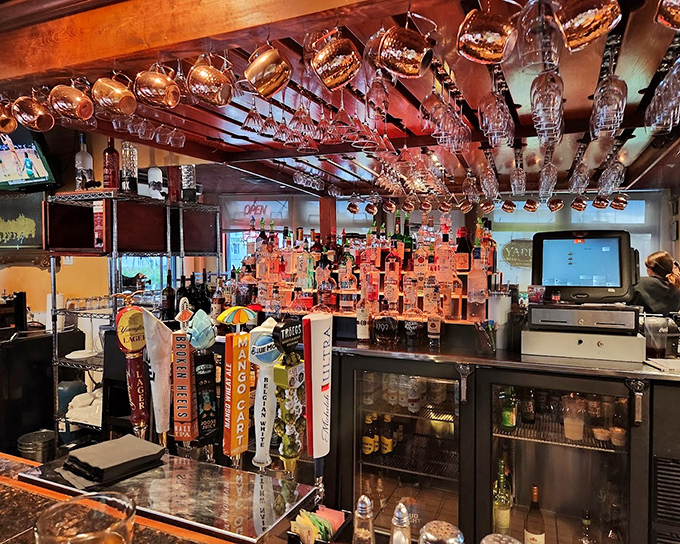 The bar area—where magic happens in liquid form. Those hanging glasses promise good times ahead.