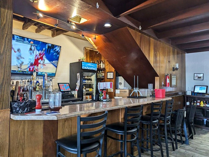 The bar area offers respite for weary travelers&mdash;wood-paneled warmth, cold drinks, and a TV that's probably showing either sports or local news. Arizona hospitality at its finest.