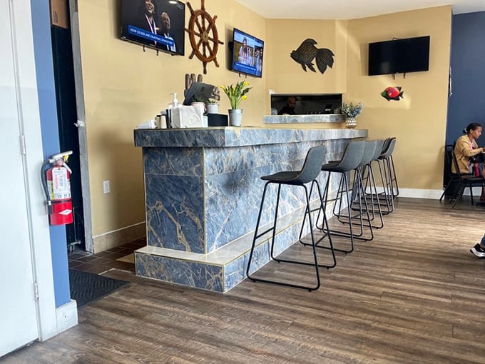 The maritime-themed bar area, where ship wheels and fish decorations remind you that your cocktail's ingredients probably have fresher passports than you do.