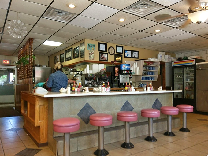 The counter seats—front-row tickets to the breakfast ballet. Those pink stools have witnessed more morning revelations than most therapists.