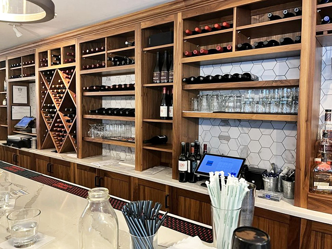 The bar's wooden shelving cradles bottles like precious artifacts, a temple to libations that pair perfectly with ocean bounty.