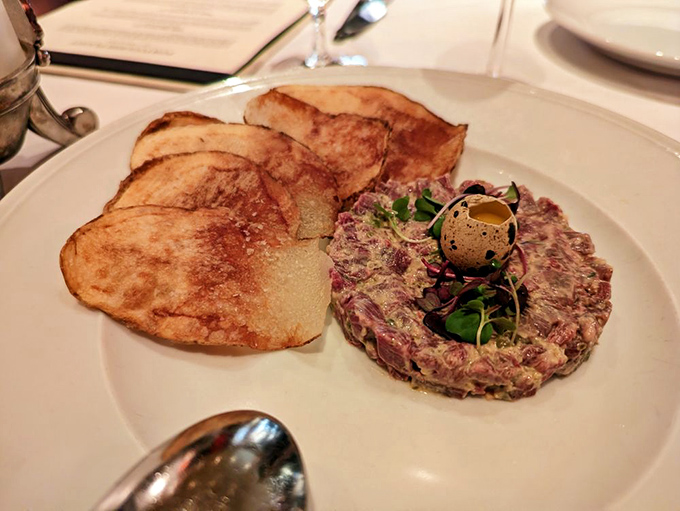 Beef tartare presented with the kind of artistry that makes you pause before taking that first bite.