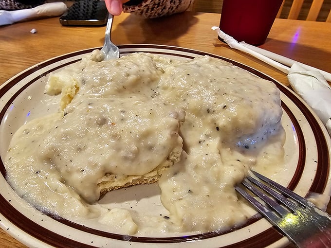 Biscuits and gravy so comforting it could end international conflicts. That fork is diving into a cloud of peppery, sausage-studded heaven.