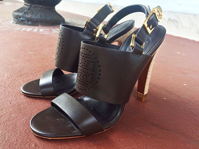 These sophisticated black heels with gold accents aren't just shoes—they're opportunity. Someone's abandoned evening plans become your next statement piece.