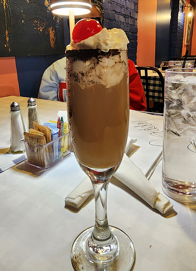 This isn't just a chocolate drink—it's dessert in a champagne flute, topped with whipped cream and a cherry that's basically saying, "Yes, it's morning. No, we don't care."