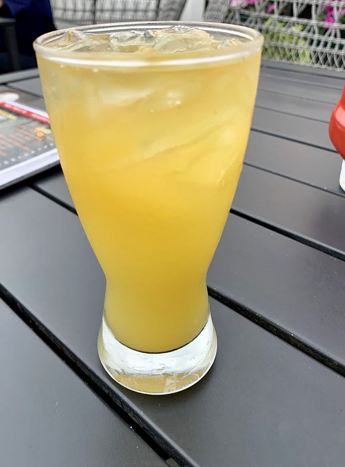 Sunshine in a glass that whispers, "Weekday responsibilities? I don't know her." The perfect companion for patio philosophizing.