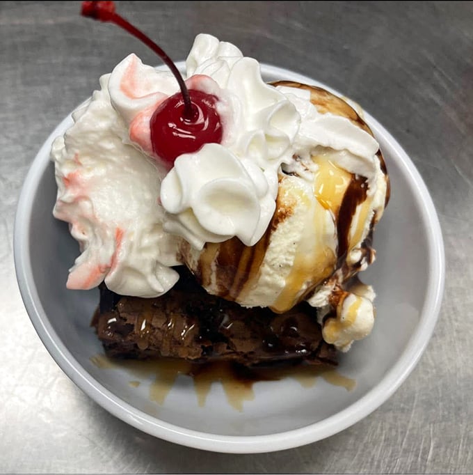 Dessert architecture at its finest&mdash;warm brownie foundation, ice cream superstructure, whipped cream clouds, and that cherry on top isn't just decoration, it's the exclamation point!