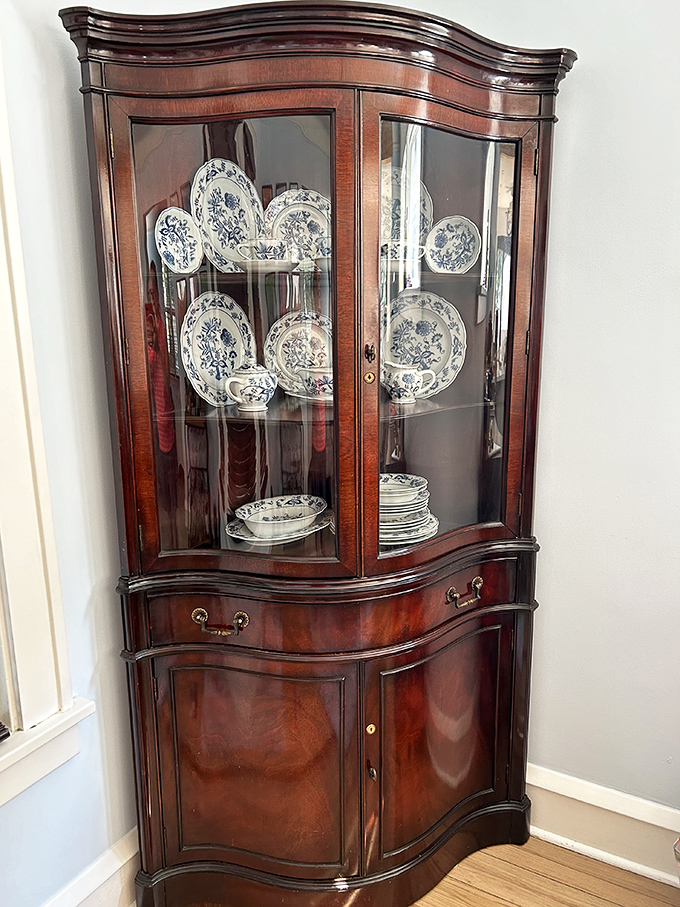 Not just a china cabinet but a museum of domestic elegance, displaying blue and white patterns that never go out of style.