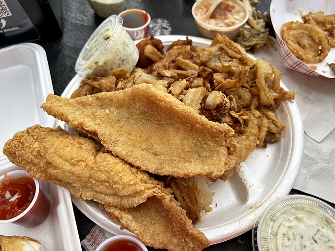 Golden-fried catfish that would make your Southern grandmother nod in approval, paired with onion rings that deserve their own fan club.